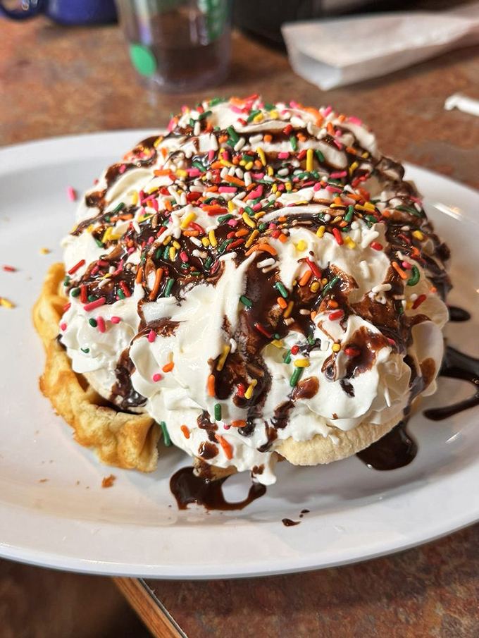 This isn't dessert, it's "breakfast dessert"—a waffle mountain topped with whipped cream, sprinkles, and permission to start your day with joy.