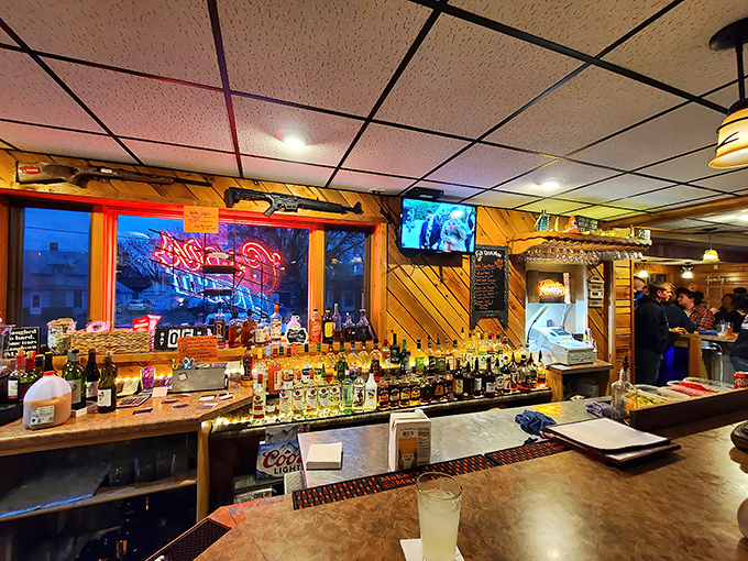 A bar stocked with enough spirits to raise your own. That neon glow isn't just ambiance—it's a beacon calling you home.