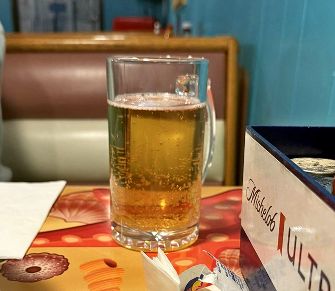 A cold beer in a proper mug—because sometimes the perfect seafood companion isn't wine, but a straightforward, honest brew.