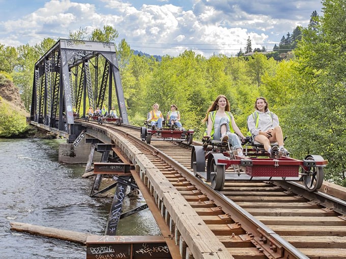 Engineering marvel meets natural wonder as railbikes cross this historic trestle bridge—a perfect metaphor for how the railroad connects travelers with Oregon's untamed beauty.