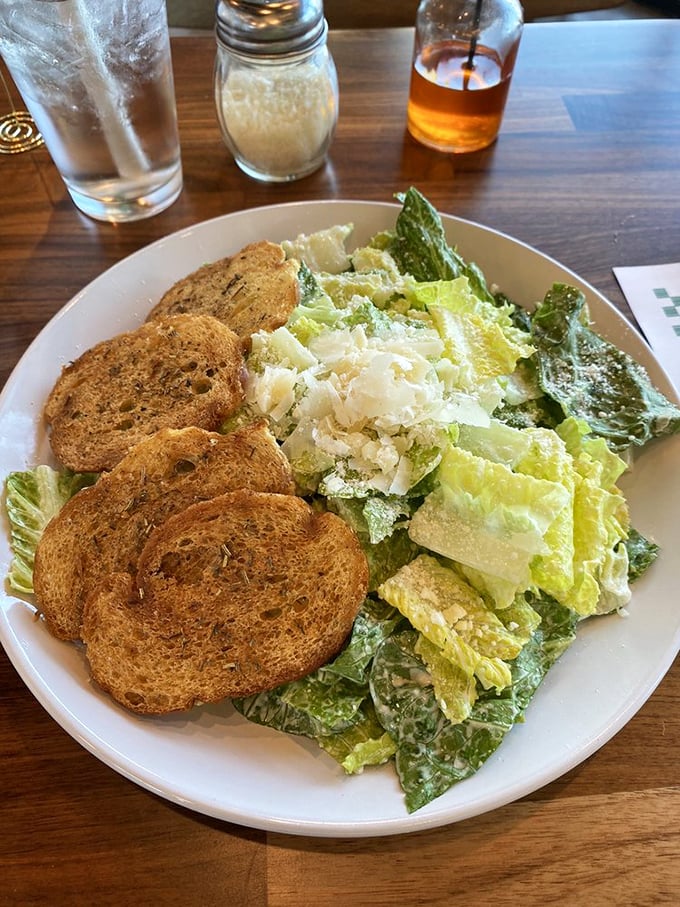 A Caesar salad that respects the classics—crisp romaine, shaved parmesan, and herbed croutons that weren't born in a bag. Simple done right.