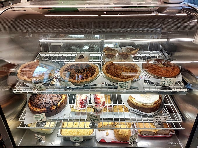 The display case: where dessert dreams come true and diets go to die. Each shelf offers a different path to sweet satisfaction.