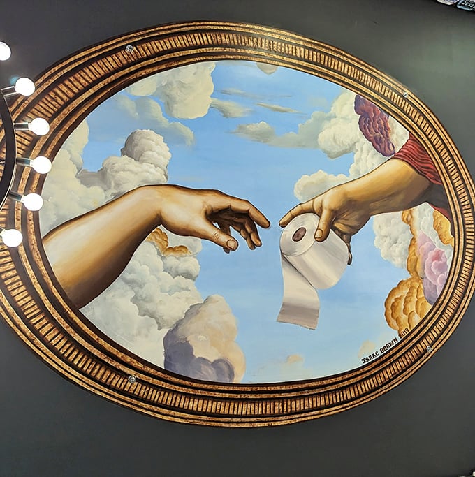 The ceiling's Sistine Chapel-inspired artwork features hands exchanging toilet paper instead of the spark of creation. Divine bathroom humor at its finest.