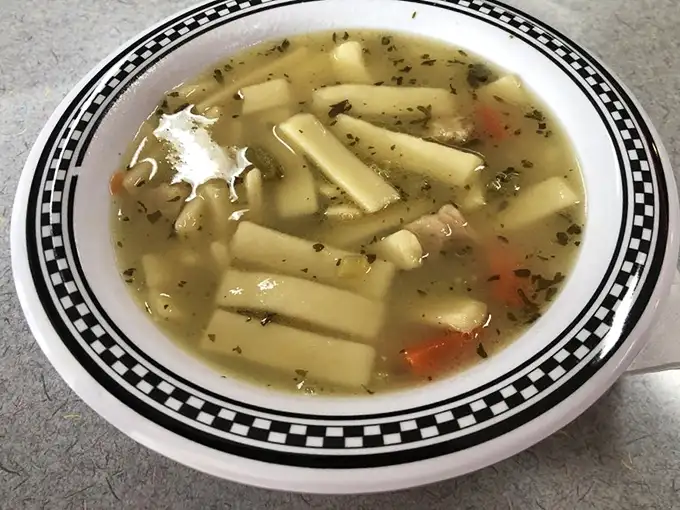 Chicken noodle soup that would make grandma nervous about her recipe. Those thick, hearty noodles swimming in golden broth are the ultimate comfort.