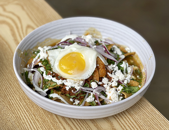 Chilaquiles crowned with a perfect egg – the breakfast royalty you didn't know you needed in your life. That queso fresco is doing the Lord's work.