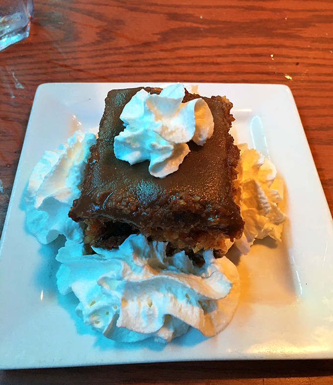 This chocolate dessert surrounded by whipped cream isn't just ending your meal—it's starting a whole new relationship with your sweet tooth.