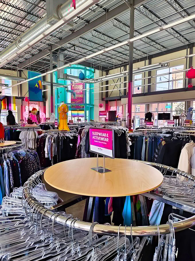 The circular clothing racks form a fashion solar system, with that Columbus t-shirt serving as the sun of local pride.