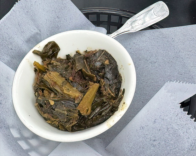 Collard greens that could convert vegetable skeptics. Slow-cooked to silky submission with just enough pot liquor to make you consider drinking it.