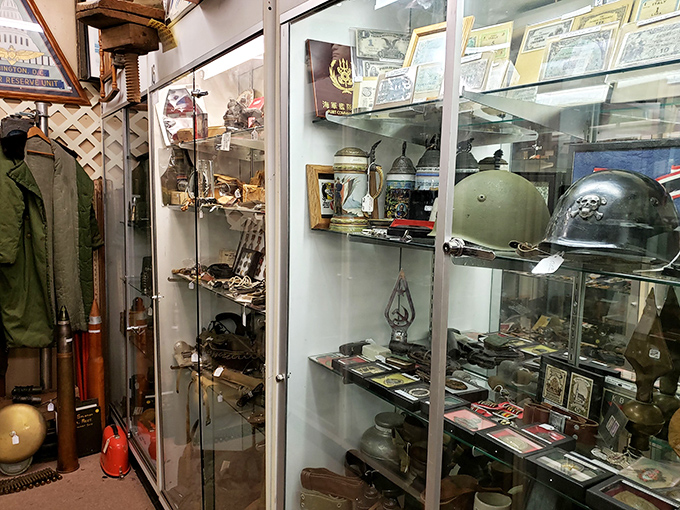 Military history preserved behind glass—helmets, uniforms, and artifacts that silently honor the sacrifices made by generations past.
