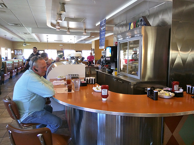 The counter seat—where solo diners become part of the diner family and the coffee refills come with a side of local wisdom.