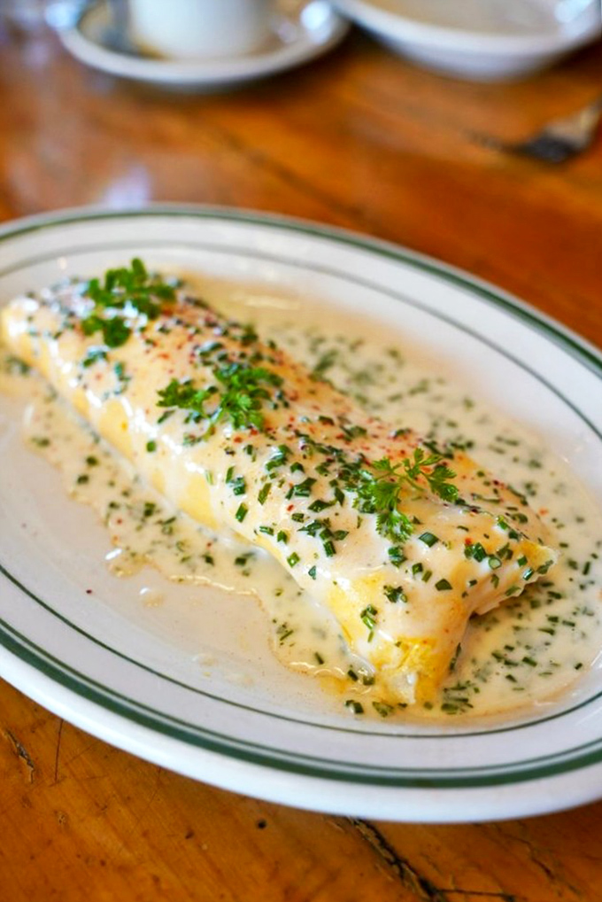 When fish meets breakfast magic—this delicate white fish bathed in herb-flecked cream sauce is morning decadence at its finest.