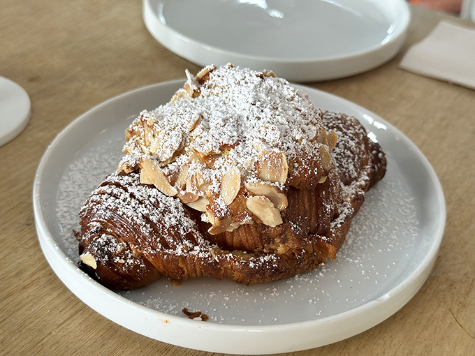 A croissant sandwich that's dressed for success – golden, flaky exterior cradling eggs and meat like they've finally found their forever home.