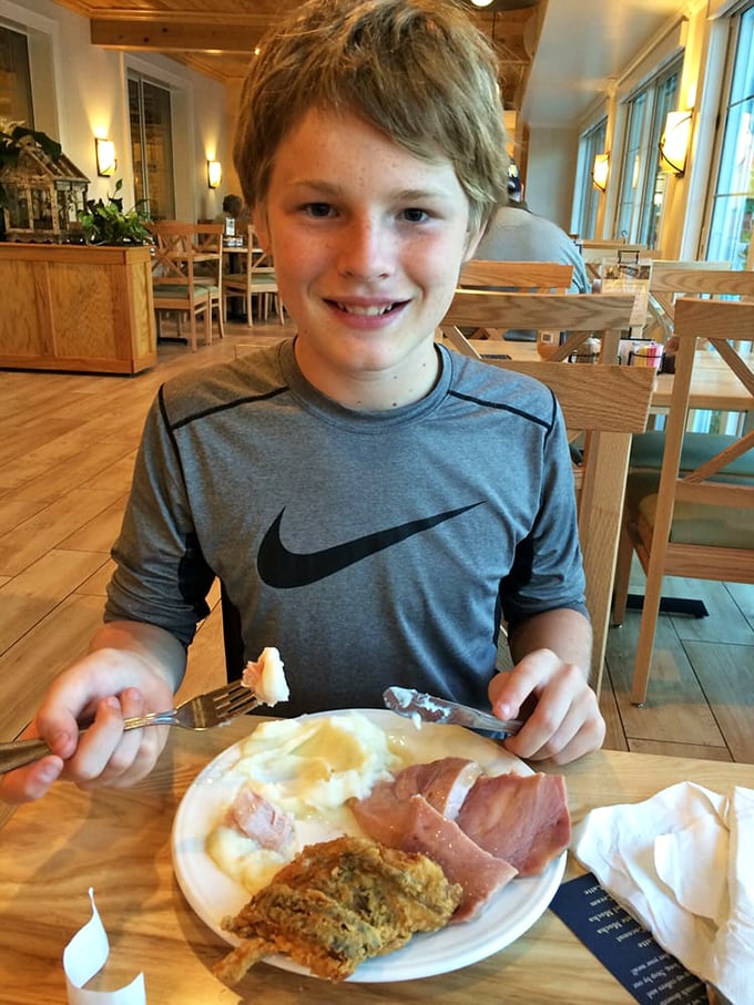 The joy on this young diner's face says it all—some food memories stick with you longer than any souvenir t-shirt ever could.