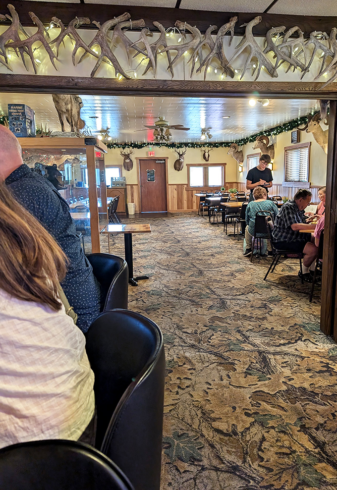 Where deer mounts meet dining tables—the dining room balances hunting lodge aesthetics with the warm comfort of your favorite relative's home.