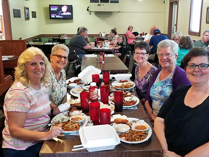Where strangers become friends over crispy poultry treasures. Notice those red cups – they're filled with sweet tea, the unofficial beverage of chicken feasts.