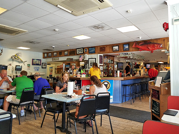 The dining room hums with the universal language of seafood appreciation. Notice the lack of phones – everyone's too busy using both hands for crab-cracking.