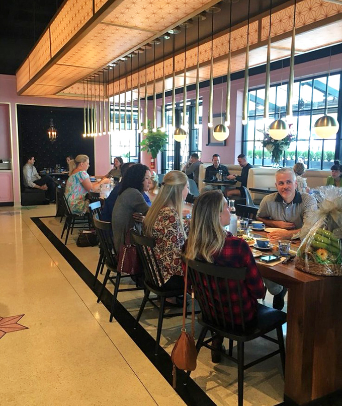 The communal table hosts a gathering of the dessert faithful—strangers united by the universal language of "you've got to try this."
