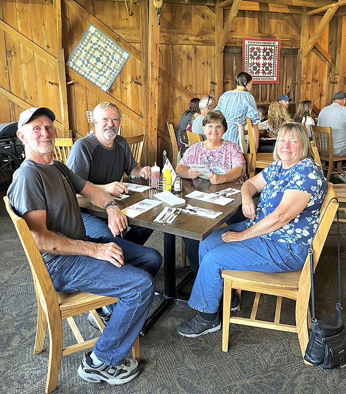 The true measure of a great restaurant: tables filled with happy diners making memories. Notice the quilts – they're not just decoration, they're conversation starters.
