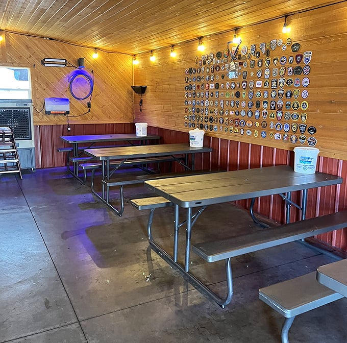 The dining area's collection of patches and badges tells stories of visitors past, while picnic tables await the next chapter of barbecue bliss.