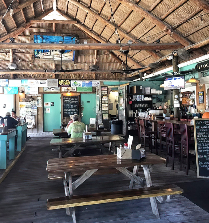 Picnic tables under a thatched roof—where strangers become friends and nobody's checking their watch or their email.