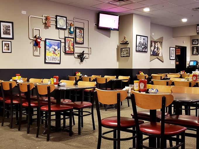 Empty tables that won't stay that way for long. The wall art collection looks like it was curated by someone's cool grandparents – eclectic and endearing.