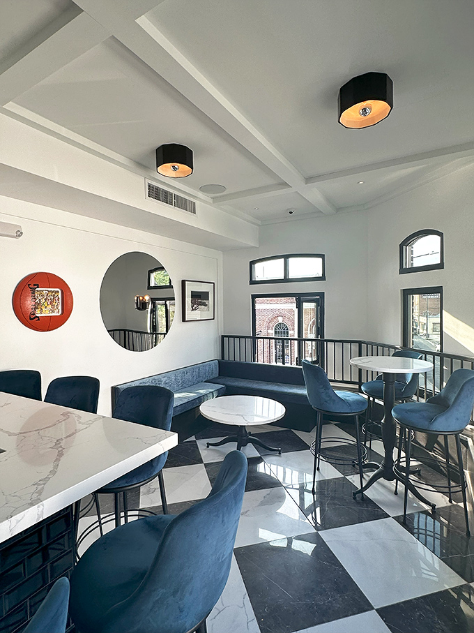 Blue velvet seating against marble and checkerboard floors—this dining space feels like the sophisticated living room you've always wanted.
