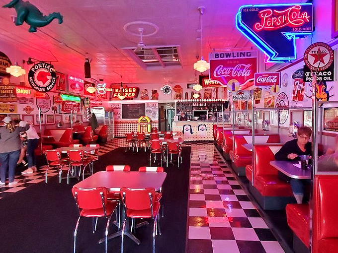 The dining area glows with neon nostalgia—red vinyl booths and chrome tables transport you to an America where rock 'n' roll was young and milkshakes were considered a food group. 