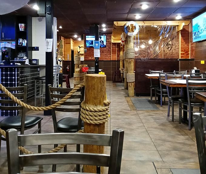 The nautical theme continues throughout, with wooden posts wrapped in rope creating natural dividers. It's like dining in the world's coziest ship that never leaves port.