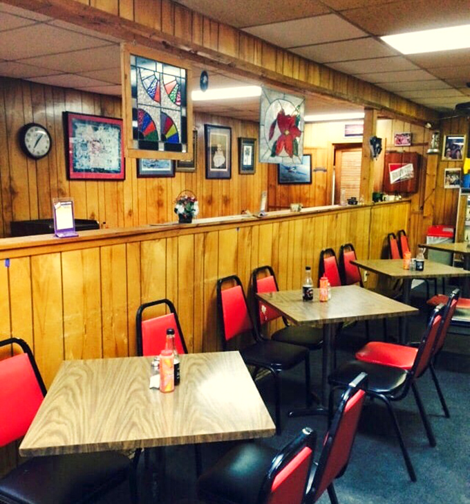 Red chairs against wood paneling—not designed by some bearded hipster, but perfected through decades of knowing exactly what matters.