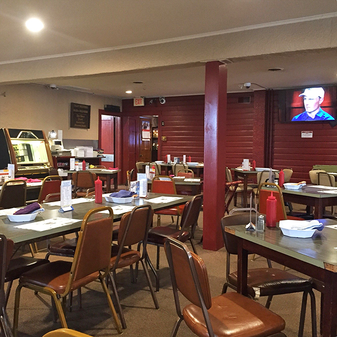 Red pillars, simple tables, and squeeze bottles of sauce standing at attention—a dining room where memories are made between bites of legendary barbecue.