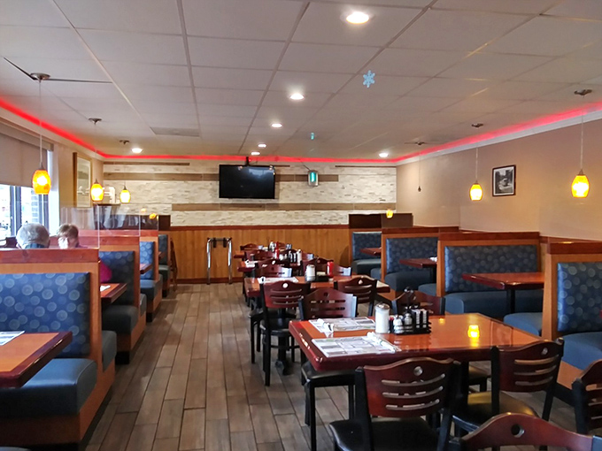 The dining room – where red accent lighting and comfortable booths create that perfect "everybody knows your name" atmosphere without trying too hard. 