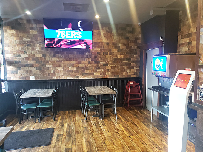 Simple tables, sports on TV, and brick walls create the perfect backdrop for focusing on what matters—the burger in front of you.