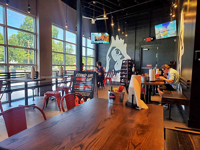 Minimalist design with maximum chicken focus. Those rooster silhouettes on the wall aren't decoration—they're memorials to the birds who sacrificed for greatness.