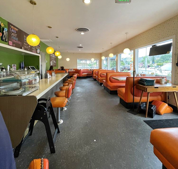 The diner's empty moment before the breakfast rush—like seeing a Broadway stage before the show. Those orange booths are ready for their starring role.