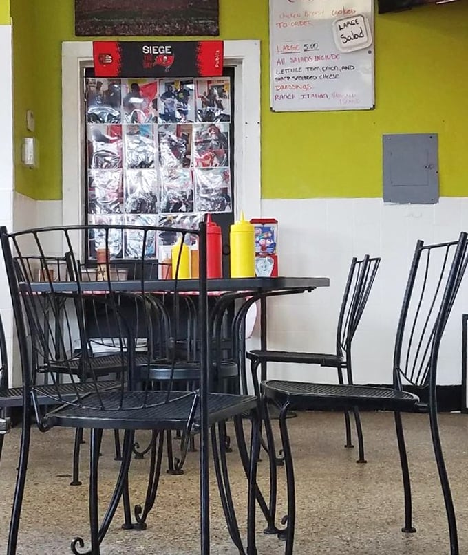 The simple dining area with its mustard-yellow walls and classic condiment bottles proves that great food doesn't need fancy surroundings to shine.