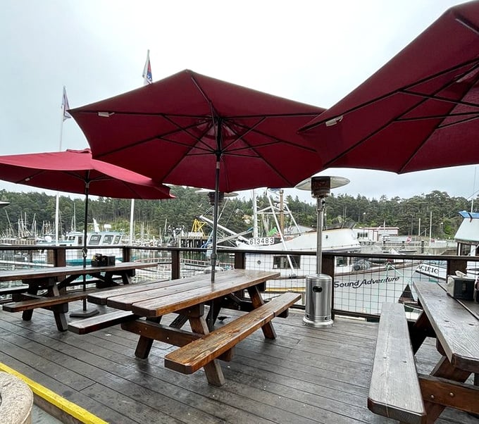 Red umbrellas, wooden picnic tables, and a front-row seat to working fishing boats—this isn't ambiance you can manufacture, folks.