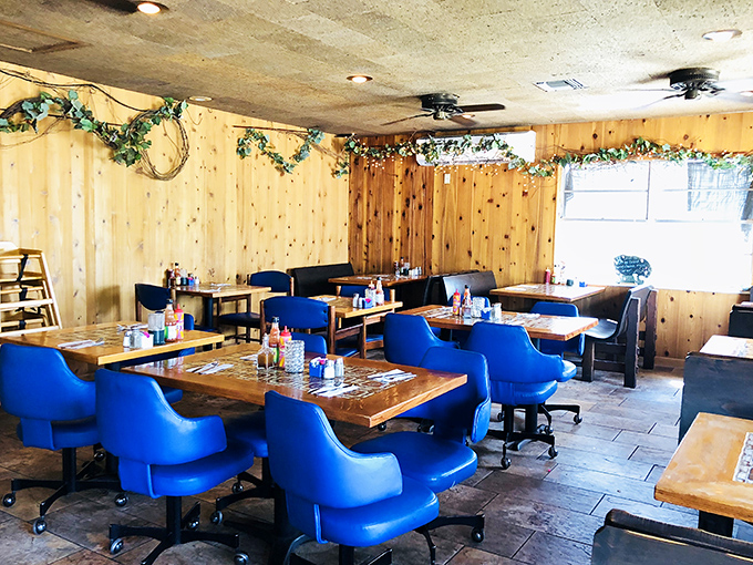 Blue chairs that pop against pine walls – simple, unpretentious dining quarters where the food, not the decor, rightfully takes center stage.