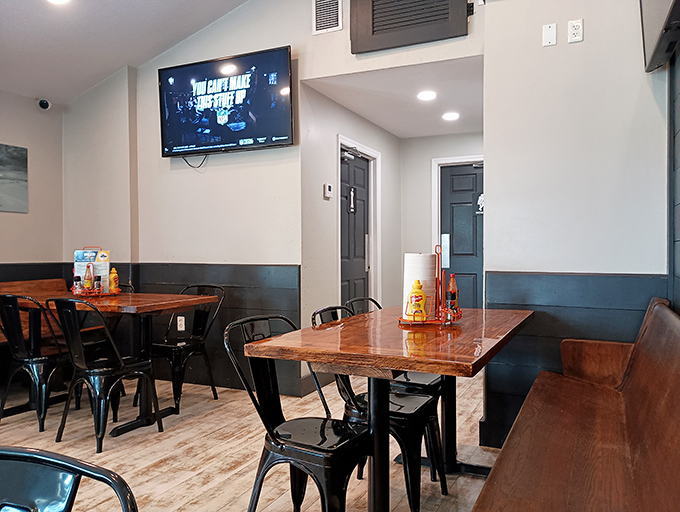 Modern rustic charm defines the dining area, where wooden tables and industrial chairs create the perfect backdrop for seafood feasting and vacation stories.