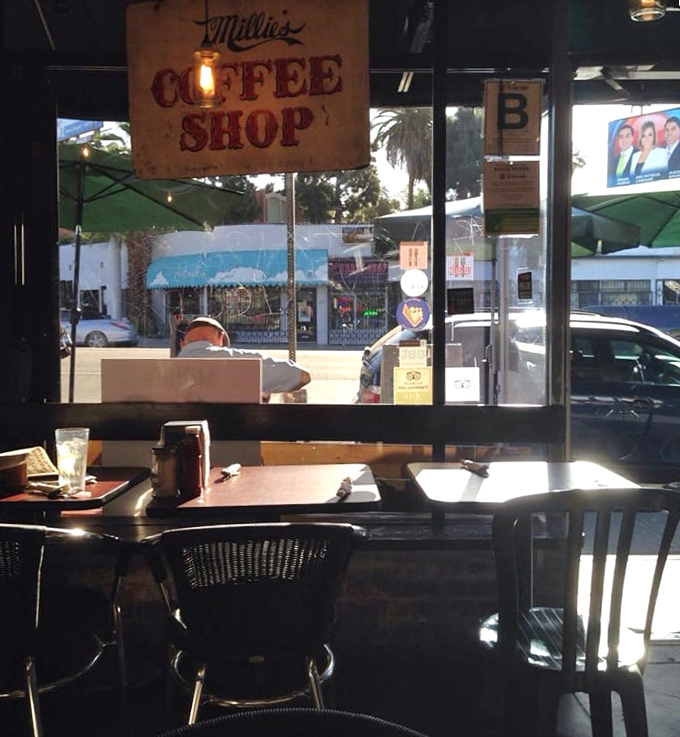 That "Coffee Shop" sign isn't just decoration—it's a promise that civilization and caffeine await inside those sunny windows.
