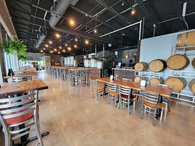 Where industrial meets inviting—wooden tables, barrel accents, and brewing equipment create a space that says "stay awhile, friend."