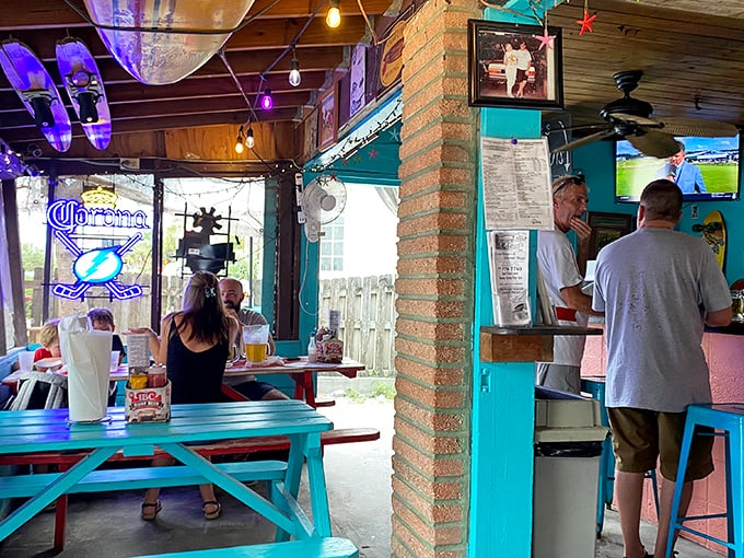 Where neon beer signs meet family photos, creating the perfect backdrop for conversations that flow as easily as the draft beer.