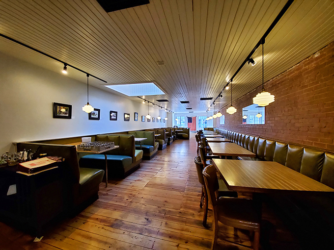 Wooden floors that have witnessed thousands of conversations, booths that invite you to settle in, and lighting that flatters everyone—diner design perfection.