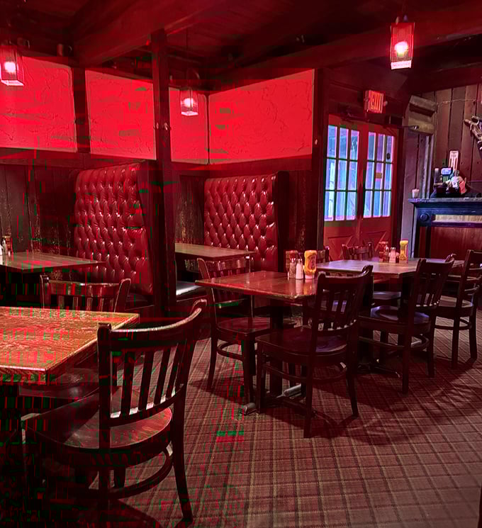 Red tufted booths and warm lighting create dining nooks that feel both private and convivial – the perfect setting for intense food focus.