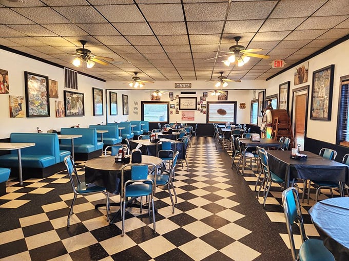 The black and white checkered floor plays visual jazz beneath turquoise chairs and booths in this temple of nostalgic dining.