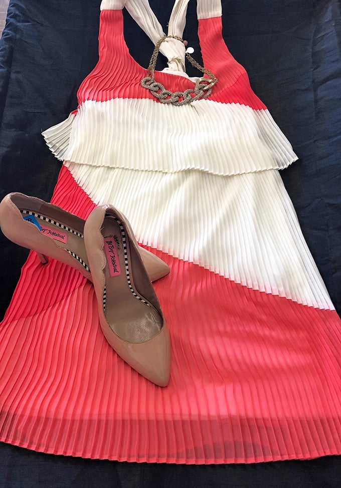A coral and white pleated dress paired with nude heels—someone's special occasion ensemble ready for its next celebration. Fashion reincarnation at its finest.