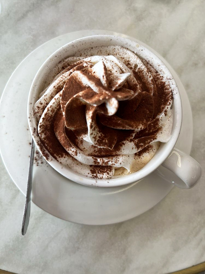 Coffee elevated to art form status. That foam swirl isn't just pretty—it's the barista whispering, "Today's going to be magnificent."