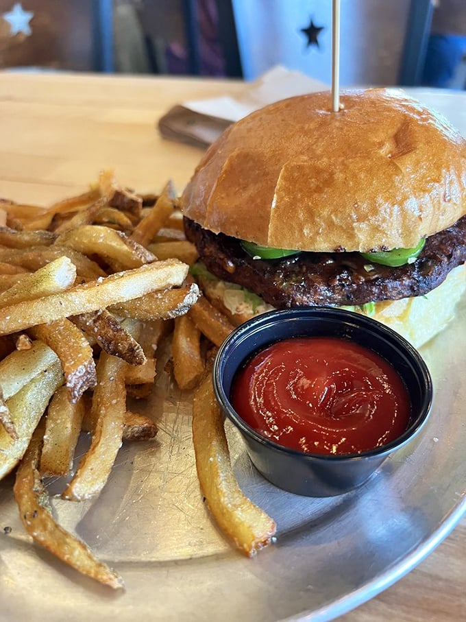 The Five Alarm burger doesn't just bring heat – it delivers a full sensory experience with cream cheese cooling the jalapeño fire. Your taste buds will need therapy afterward.