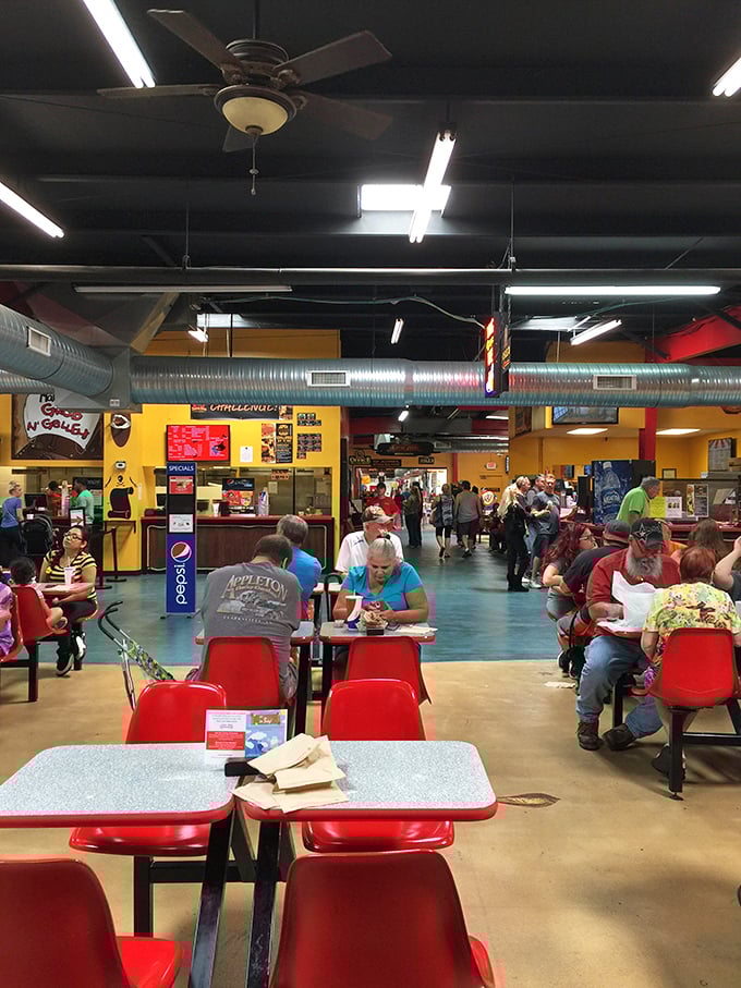 The bustling food court serves as both refueling station and social hub. Those red chairs have heard more bargaining stories than most bartenders.