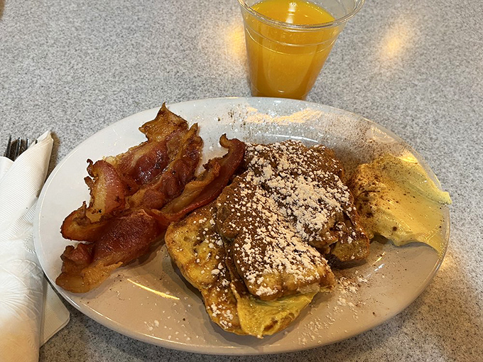 French toast and bacon: the breakfast power couple that never disappoints. That dusting of powdered sugar isn't just garnish—it's the fairy dust of morning magic.