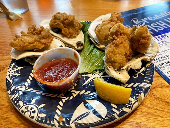 Oysters wearing their golden-fried Sunday best, perched on shells like tiny seafood thrones awaiting your royal approval.